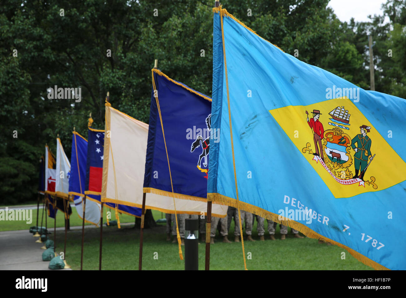 State flags are posted during a change of command ceremony aboard Camp ...