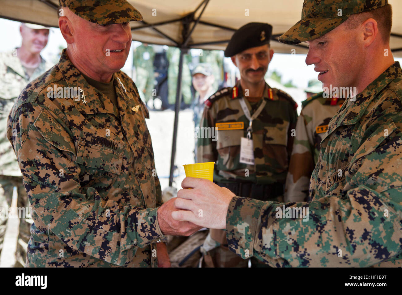 U.S. Marine Sgt. Robert W. Walker, right, provides a sample of purified ...