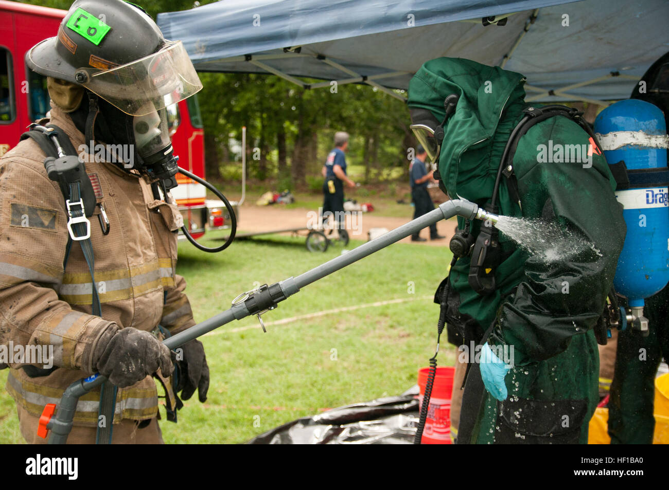 A firefighter from the Tulsa Fire Department decontaminates an Oklahoma ...
