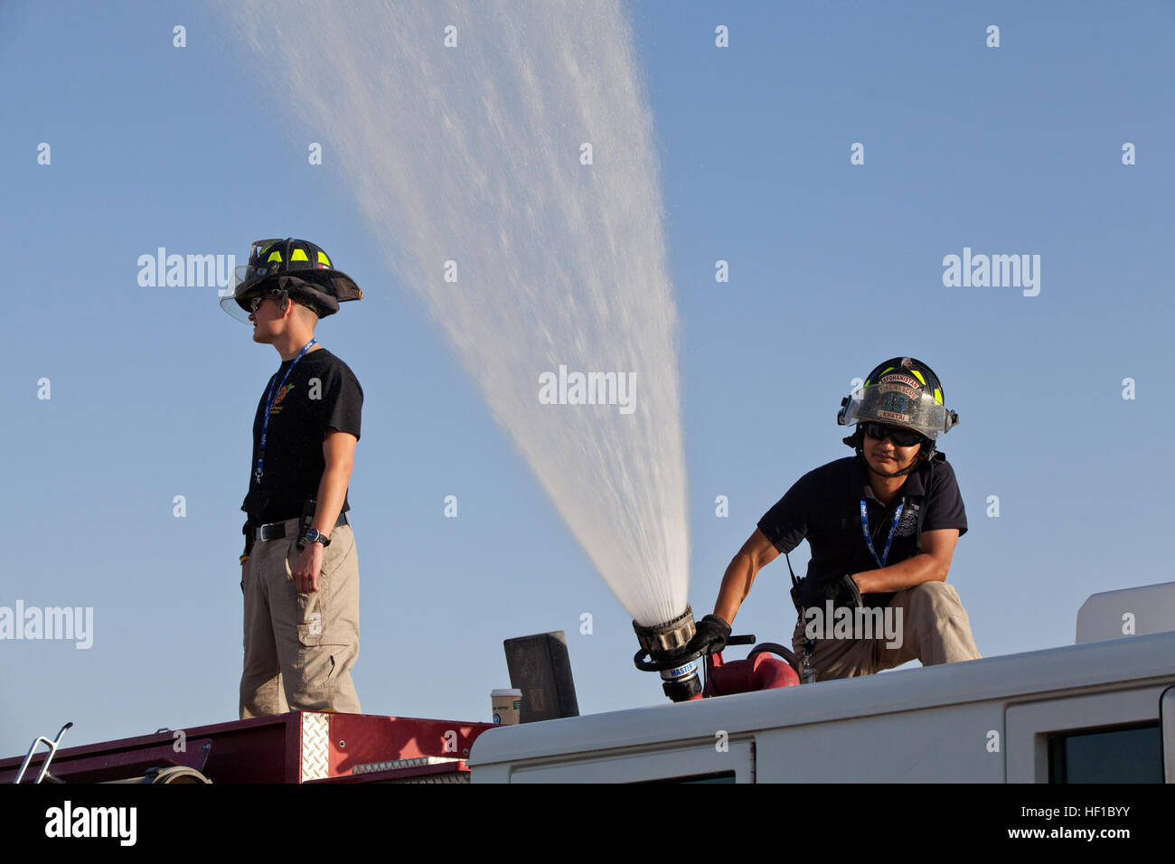 Afghanistan Fire Rescue crewmen spray water on U.S. Service members ...