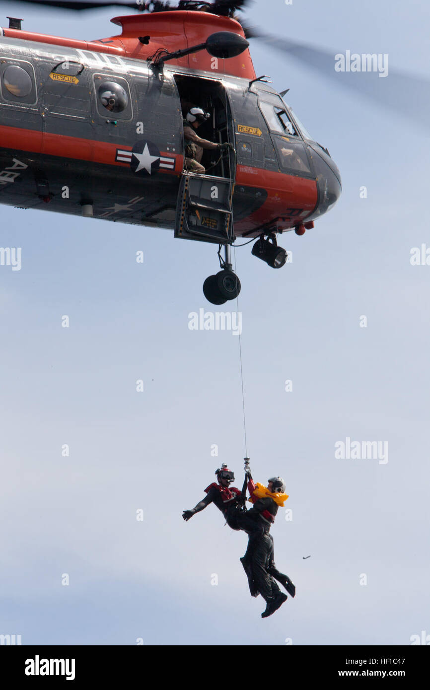 Marine Transport Squadron 1 Marines and Sailors are hoisted into an HH ...
