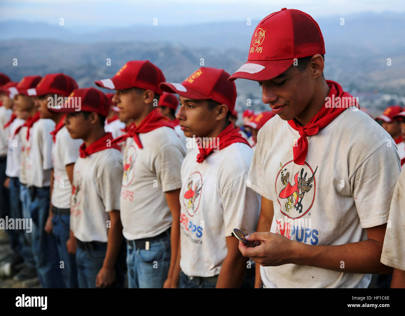 A Devil Pups stands and admires his challenge coin in formation on top of the Alpha shelf in the ...