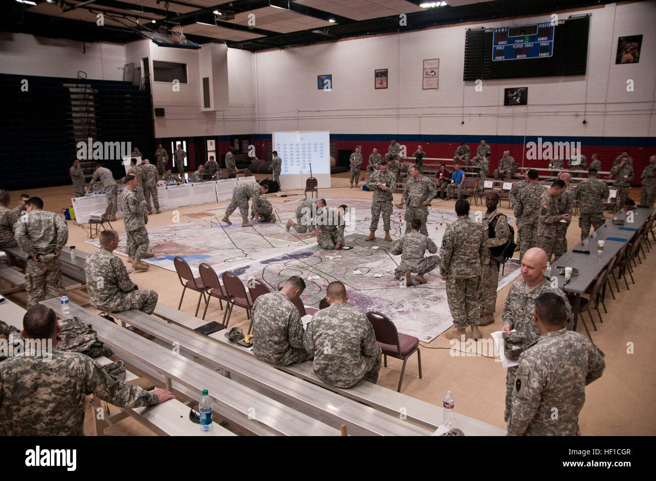 Soldiers from the 36th Infantry Division gather by a map board for a ...