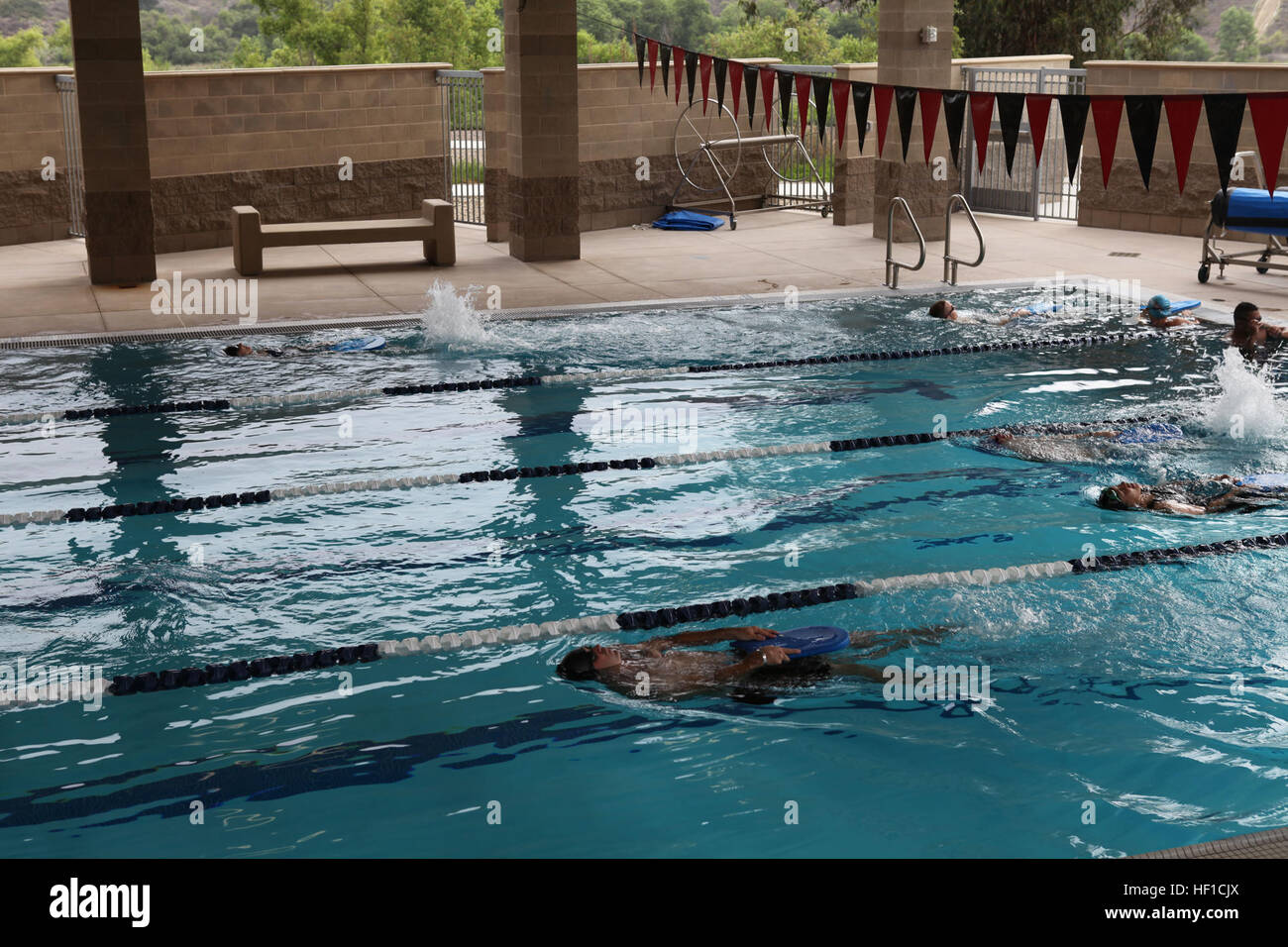 Swimmers focus on proper form while practicing backstroke technique ...