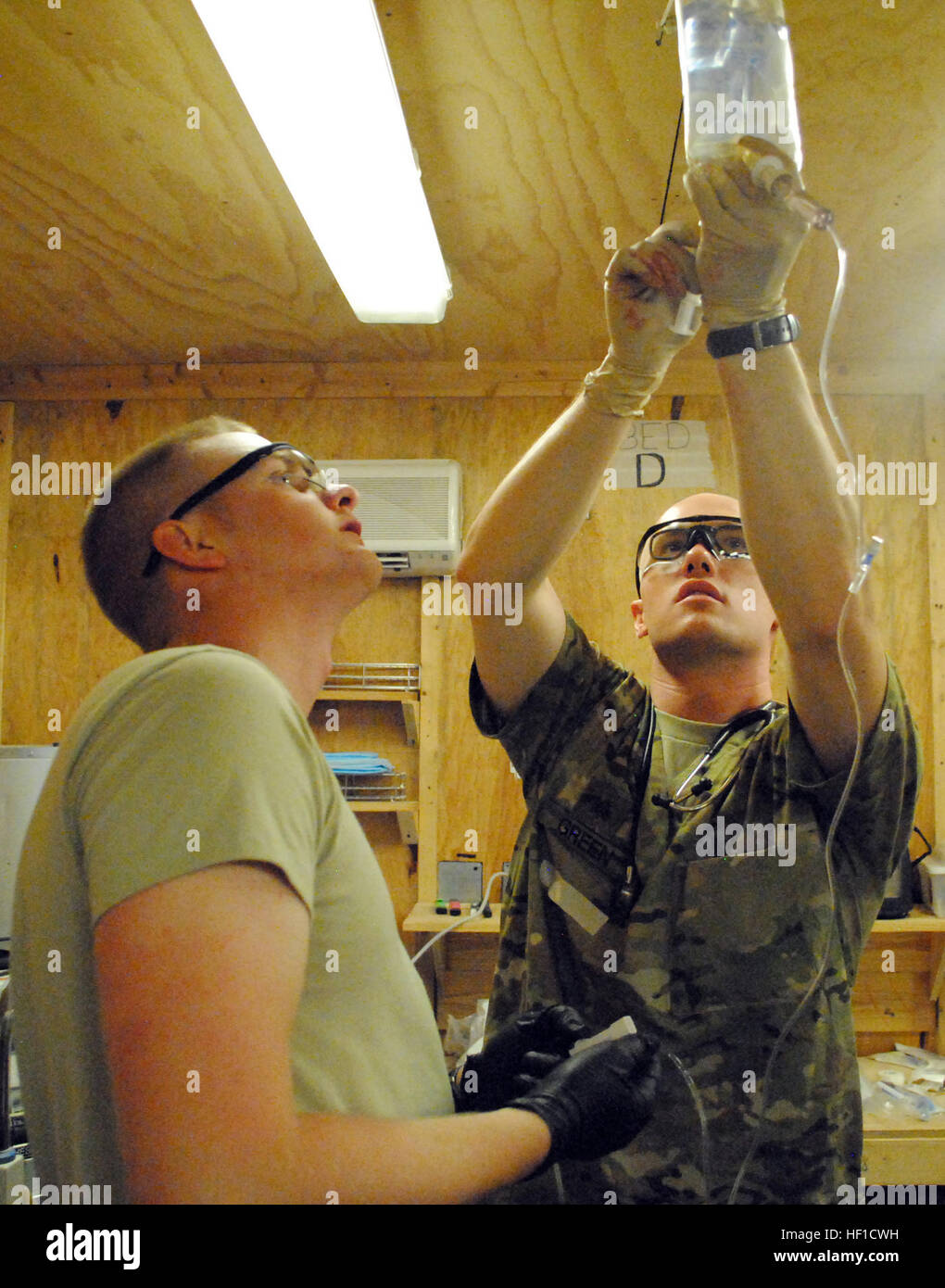 U.S. Army Pfc. Ross Cole (left) and Sgt. Brandon Green (right), medics ...