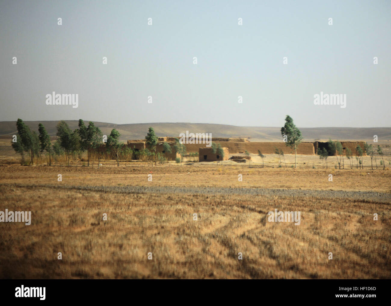 An Afghan compound sits in the distance as a combat logistics patrol ...