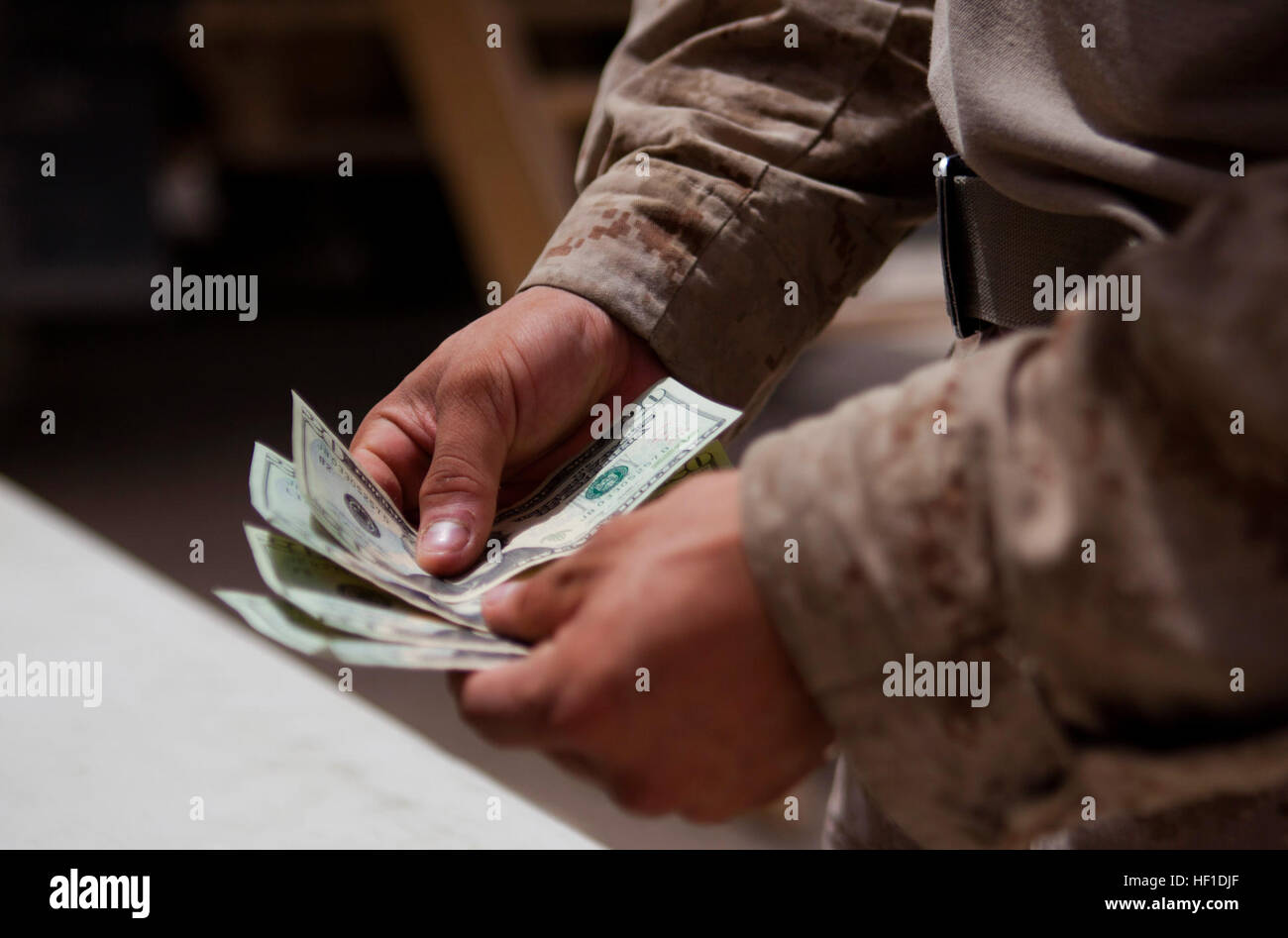 A Marine counts money recently drawn from a disbursing Marine during a ...