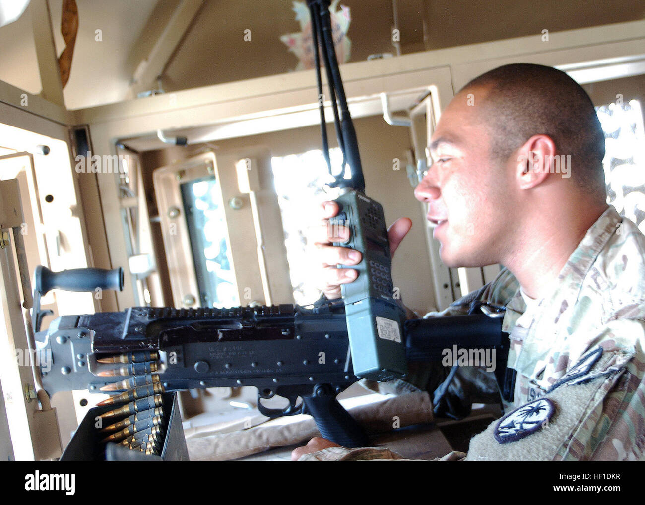 A National Guard soldier uses a radio at an entry control point in Camp ...