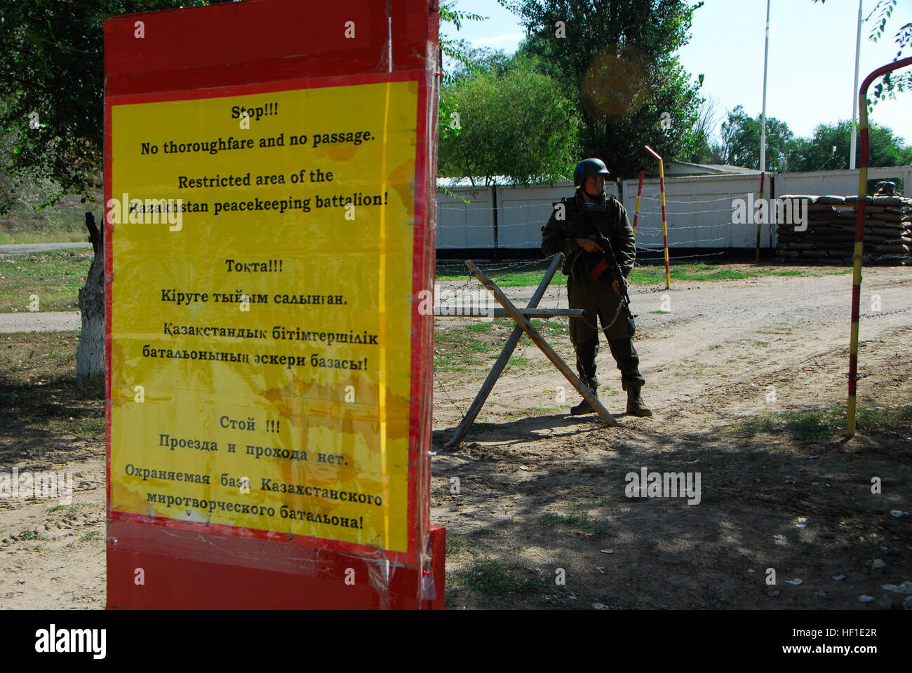 A Kazakhstani soldier stands guard while conducting camp security ...