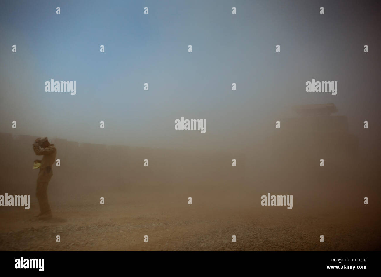 A flash sand storm engulfs a Marine with Combat Logistics Regiment 2 ...