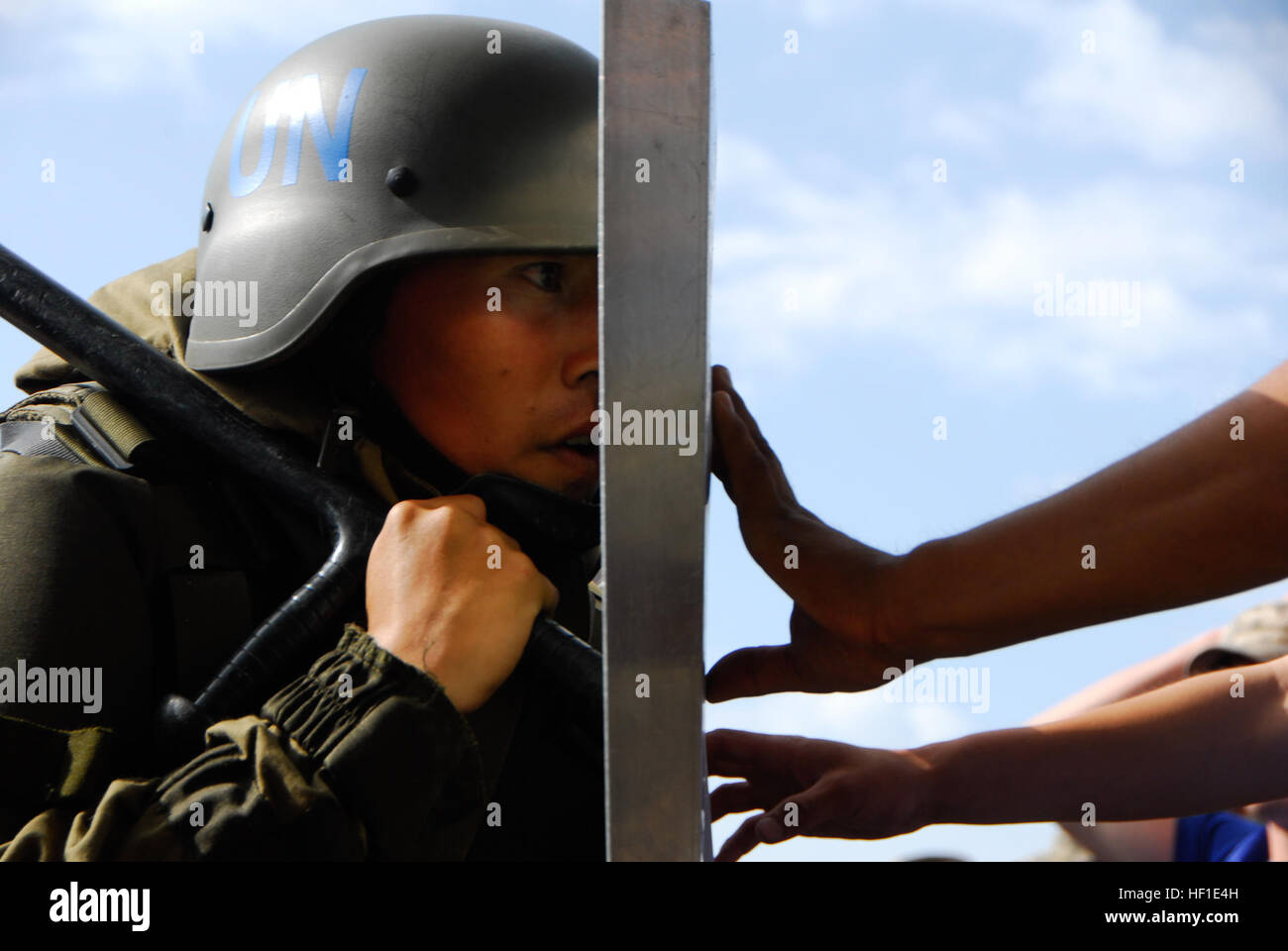 A Kazakhstani soldier uses a riot shield against civilians role-playing ...