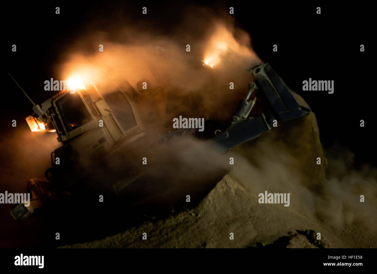 A bulldozer plows through a sand berm during infrastructure improvement ...