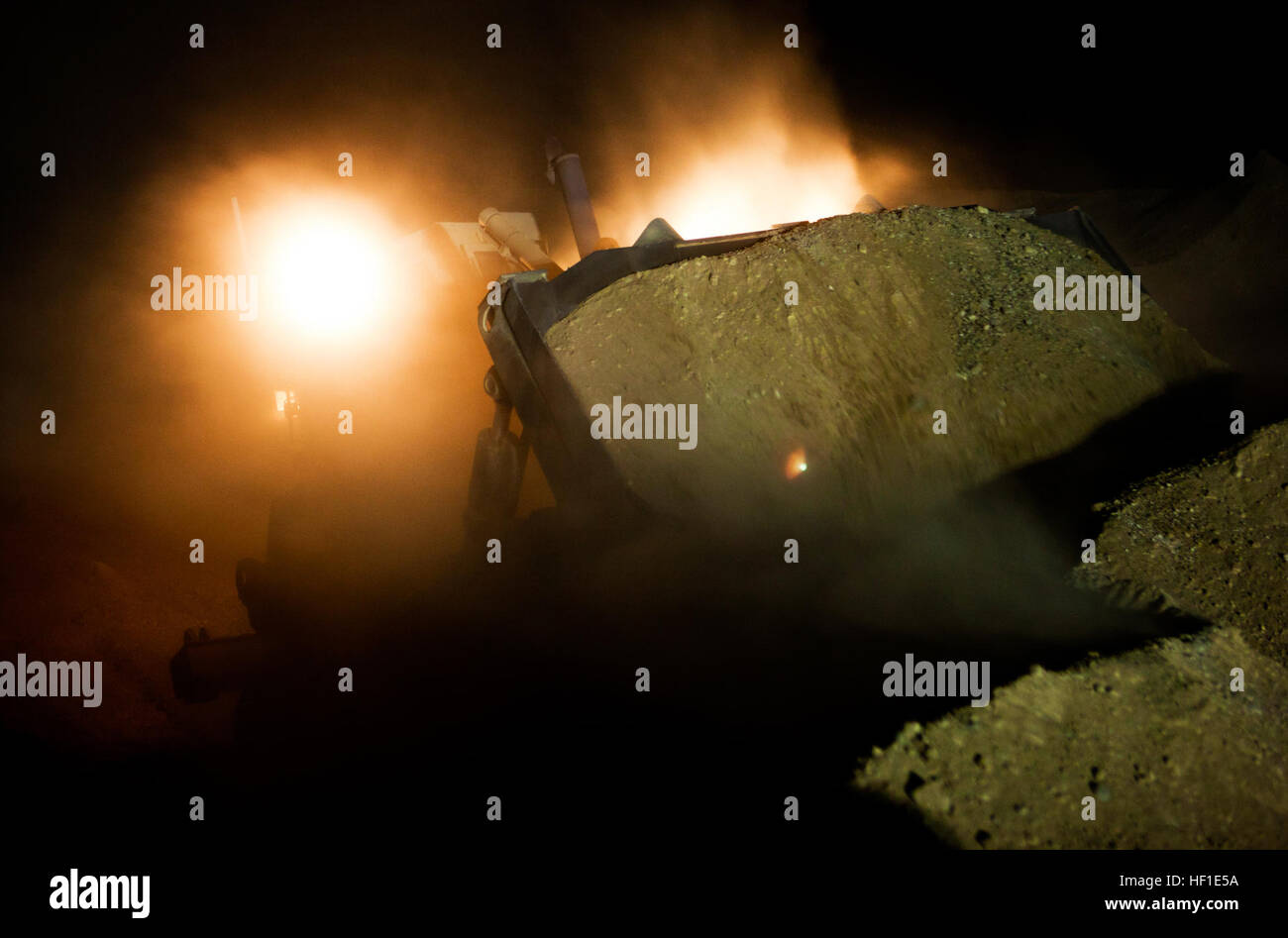 A bulldozer plows through a sand berm during infrastructure improvement ...
