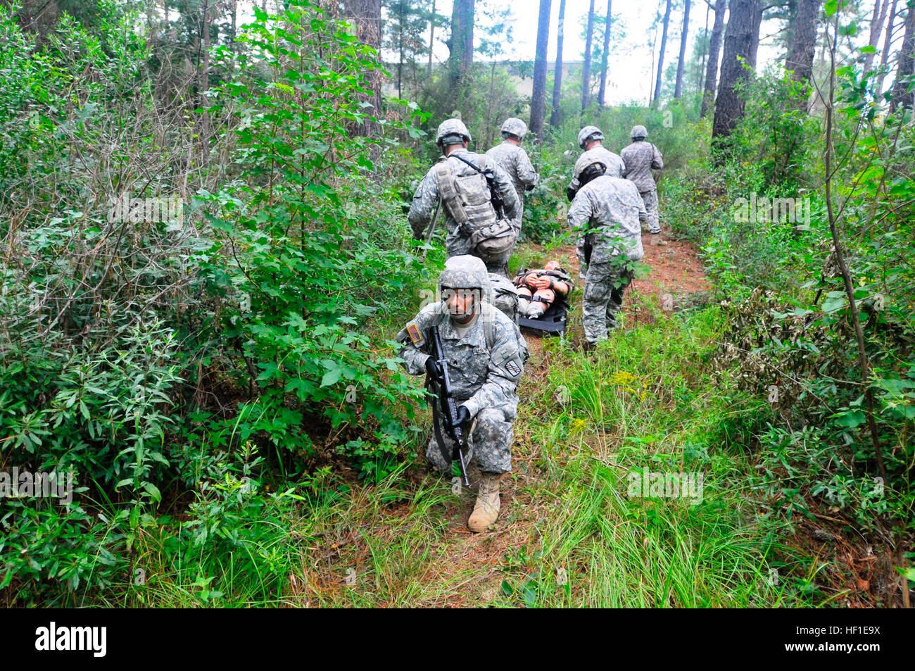 U.S. Army Sgt. Rey Acosta takes up the rear guard as his squad carries ...