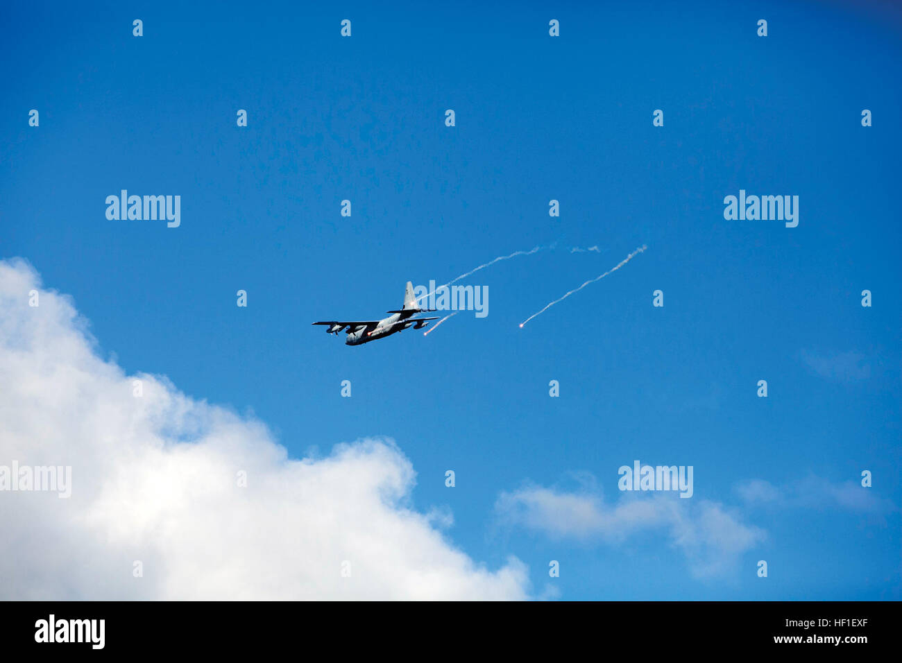 A KC-130J Super Hercules releases flares above a training island off Ie ...
