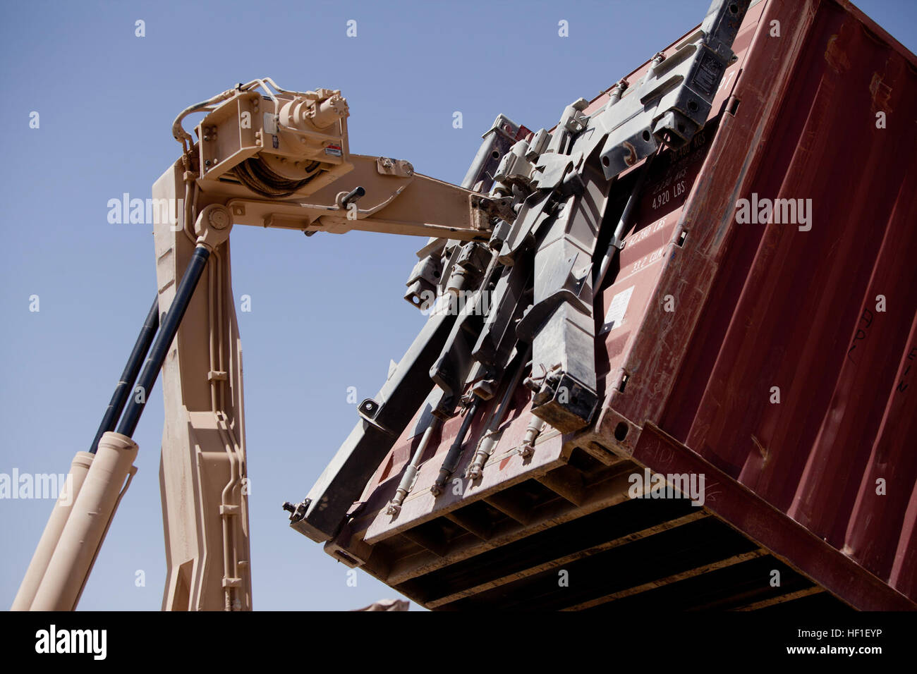 A lift-arm hauls a storage unit at Forward Operating Base Now Zad ...