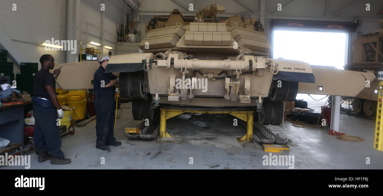 An assault breaching vehicle (ABV) is lifted and disassembled at Marine ...