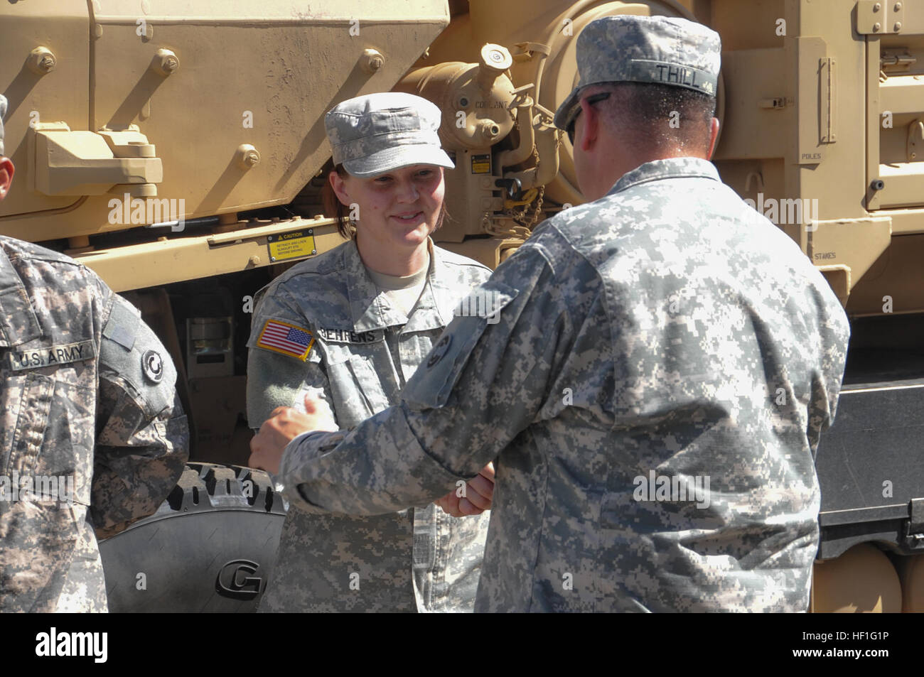 Pfc. Ruth Behrens, 1157th Forward Support Company, shakes hands with ...