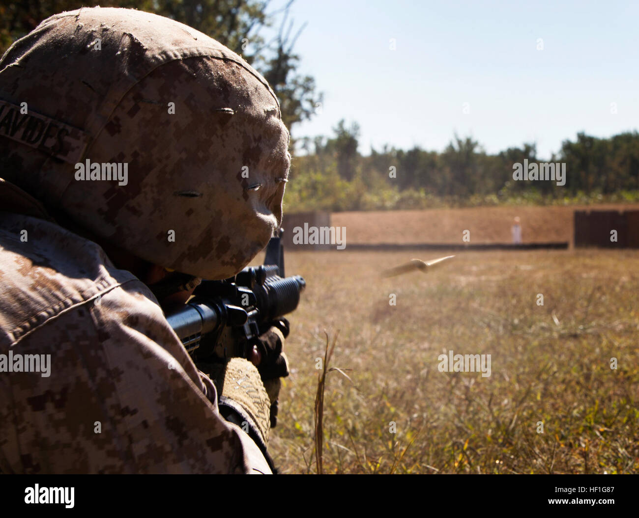 A Marine combat instructor fires from prone, standing, and kneeling ...