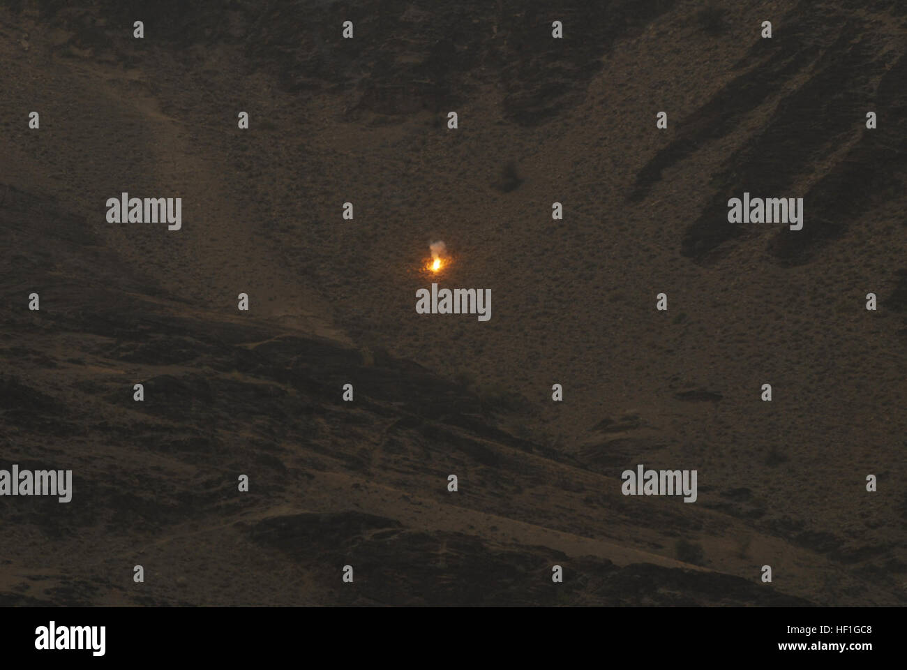 An illumination mortar shell floats down to earth after being fired ...