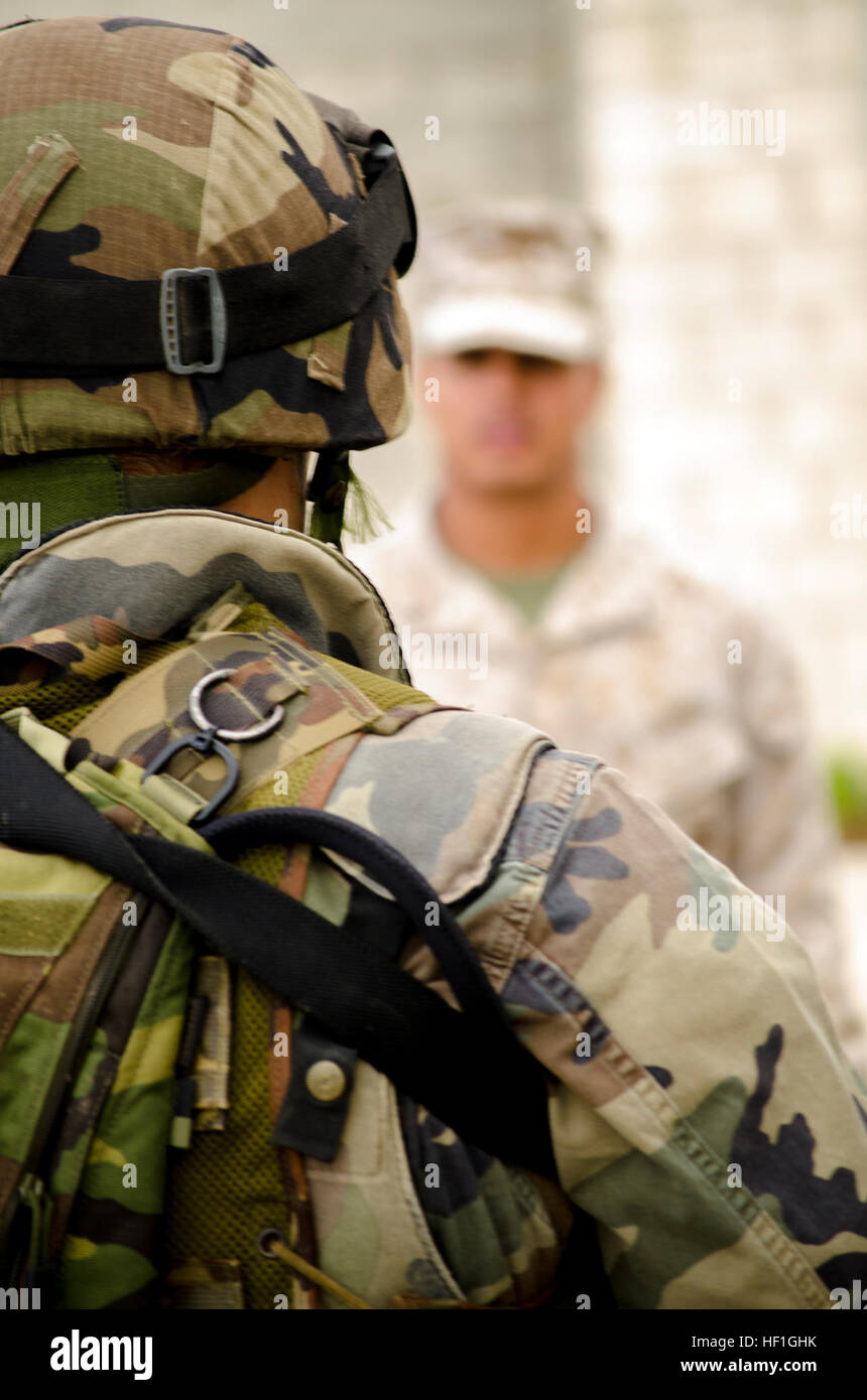 A Spanish infantry marine, foreground, listens as U.S. Marine Corps ...