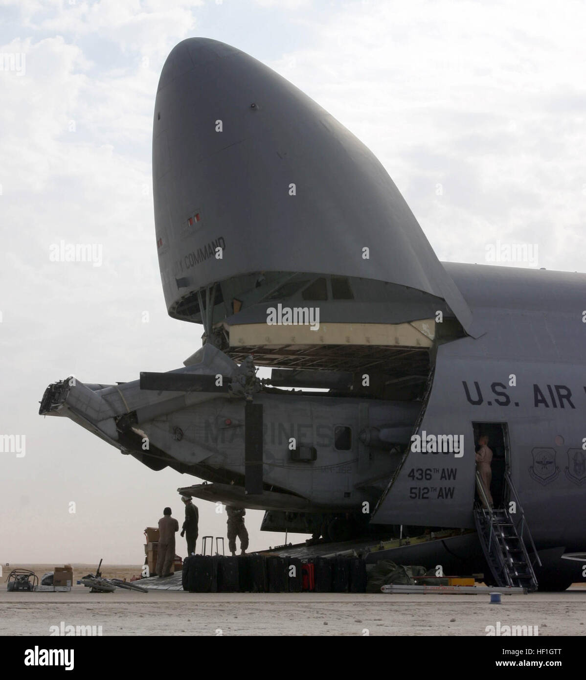 A U.S. Air Force C-5 Galaxy transport aircraft is loaded with CH-53E ...