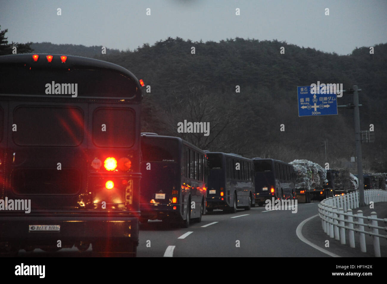 A convoy of supply trucks and buses wind their way south from Misawa ...
