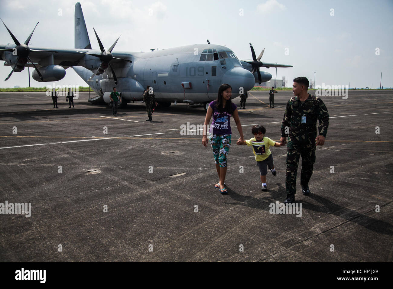 A family views U.S. Marine aircraft at Clark Air Field, Pampanga ...