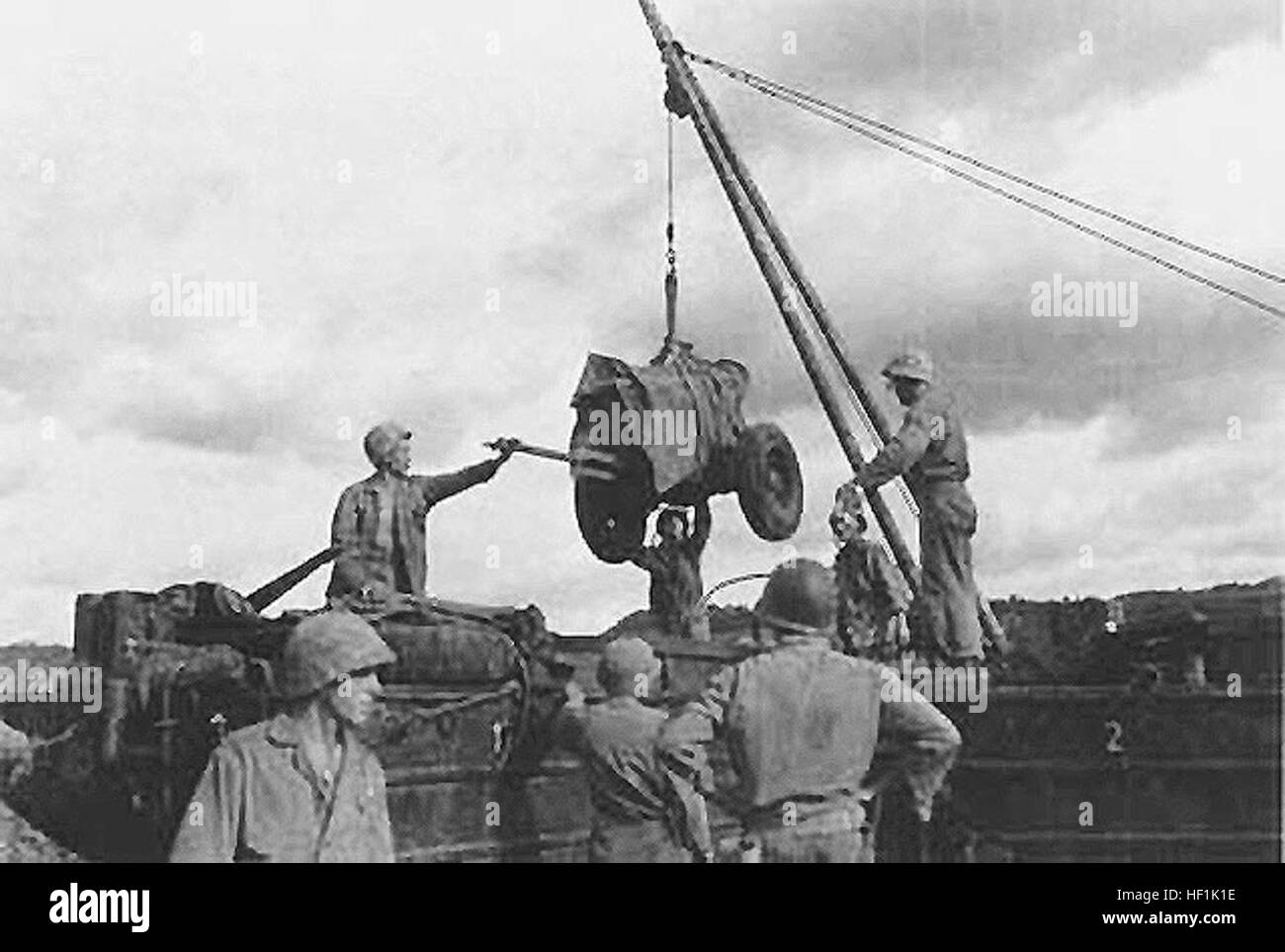 A 75mm howitzer is positioned on Tinian, showing artillery placement ...
