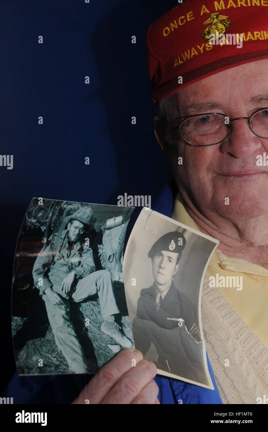 Former Cpl. Daniel Sharkey displays photos taken of himself as a young ...