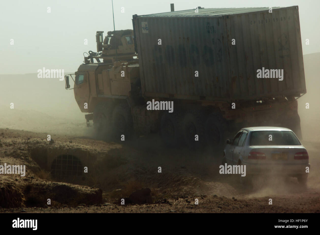 A Logistics Vehicle System Replacement drives down a desert road near ...