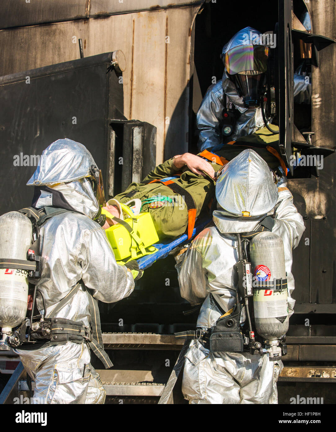 Aircraft Rescue and Firefighting personnel evacuate an injured aircraft ...
