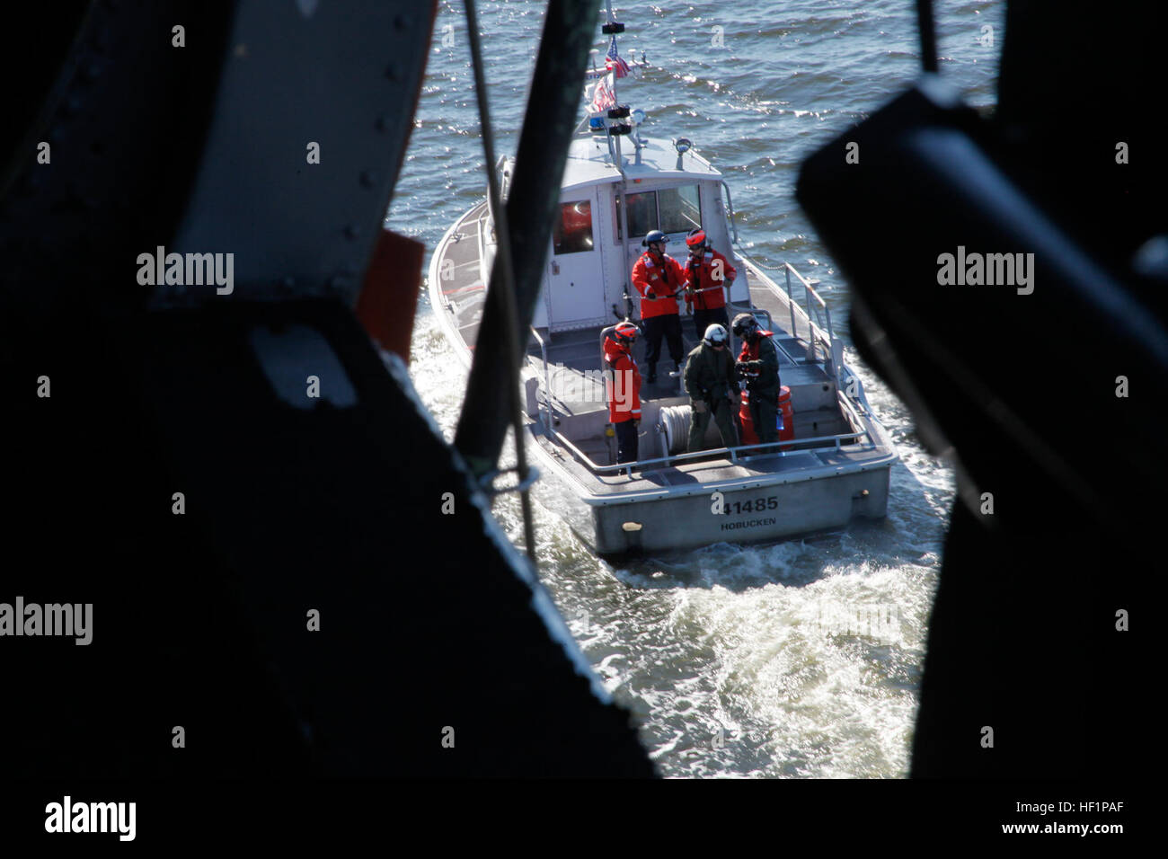 A Coast Guard utility boat conducts hoisting training with an HH-46E ...