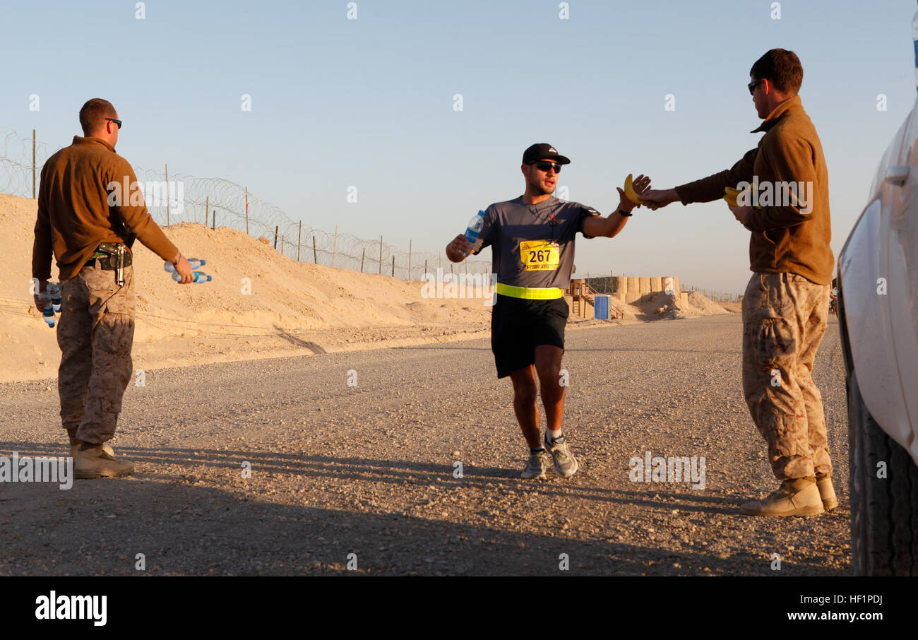 Volunteers pass out bananas and water to runners during the marathon ...