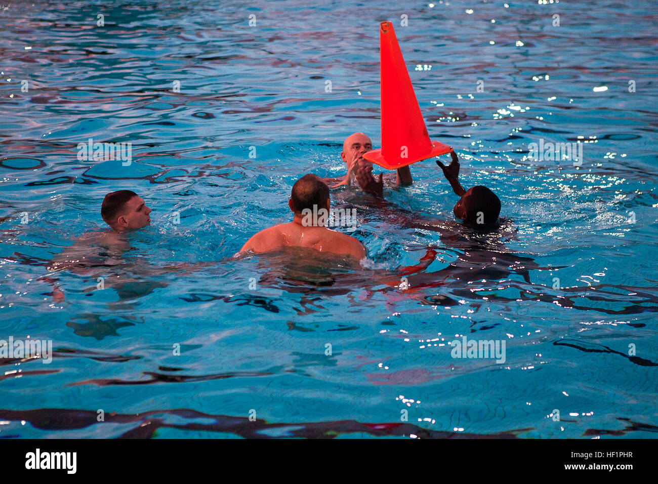 Marines pass around a traffic cone while treading water for warm ups at ...