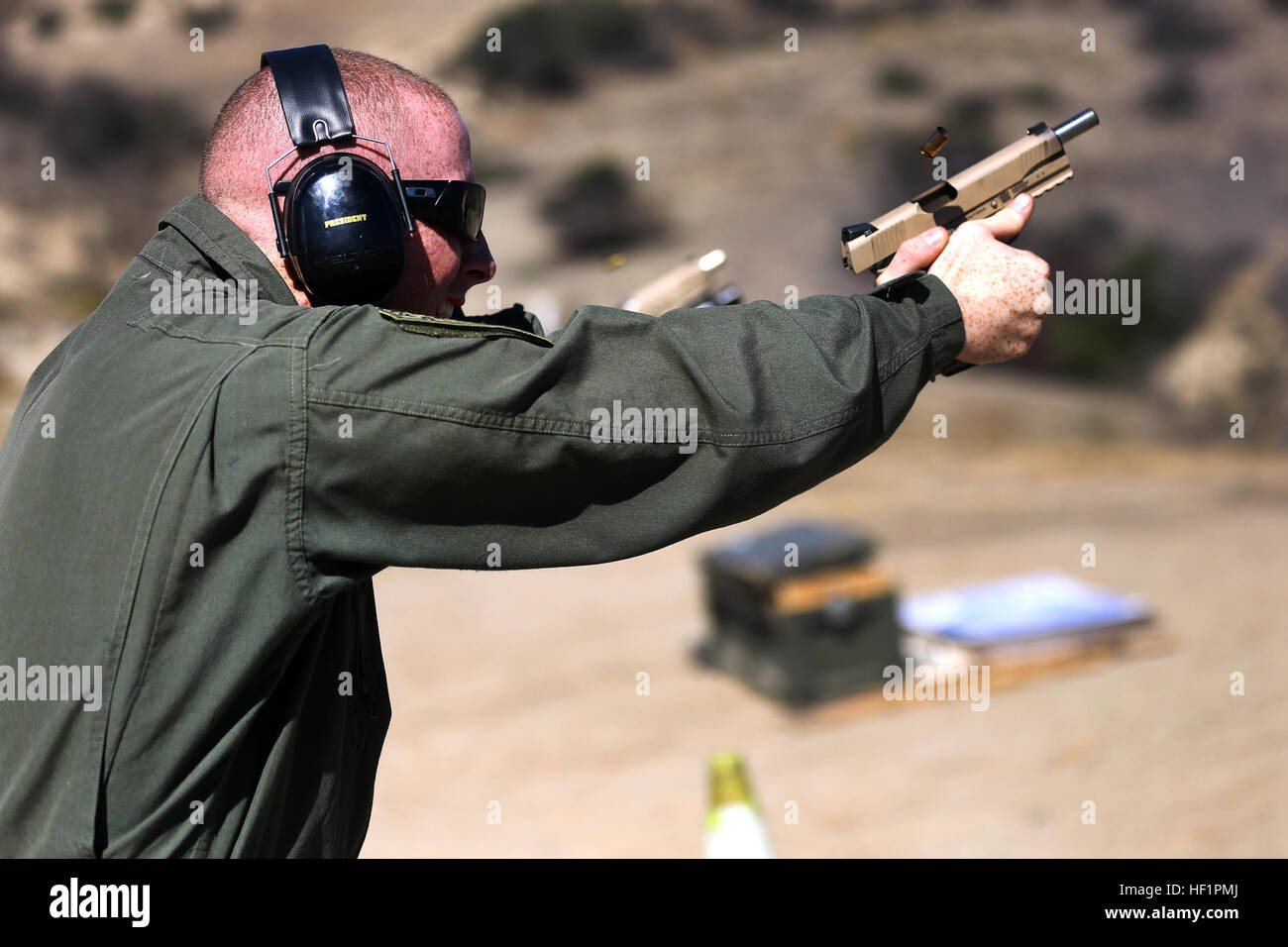 Cpl. Nicholas Day fires his M45A1 pistol during a training range held ...