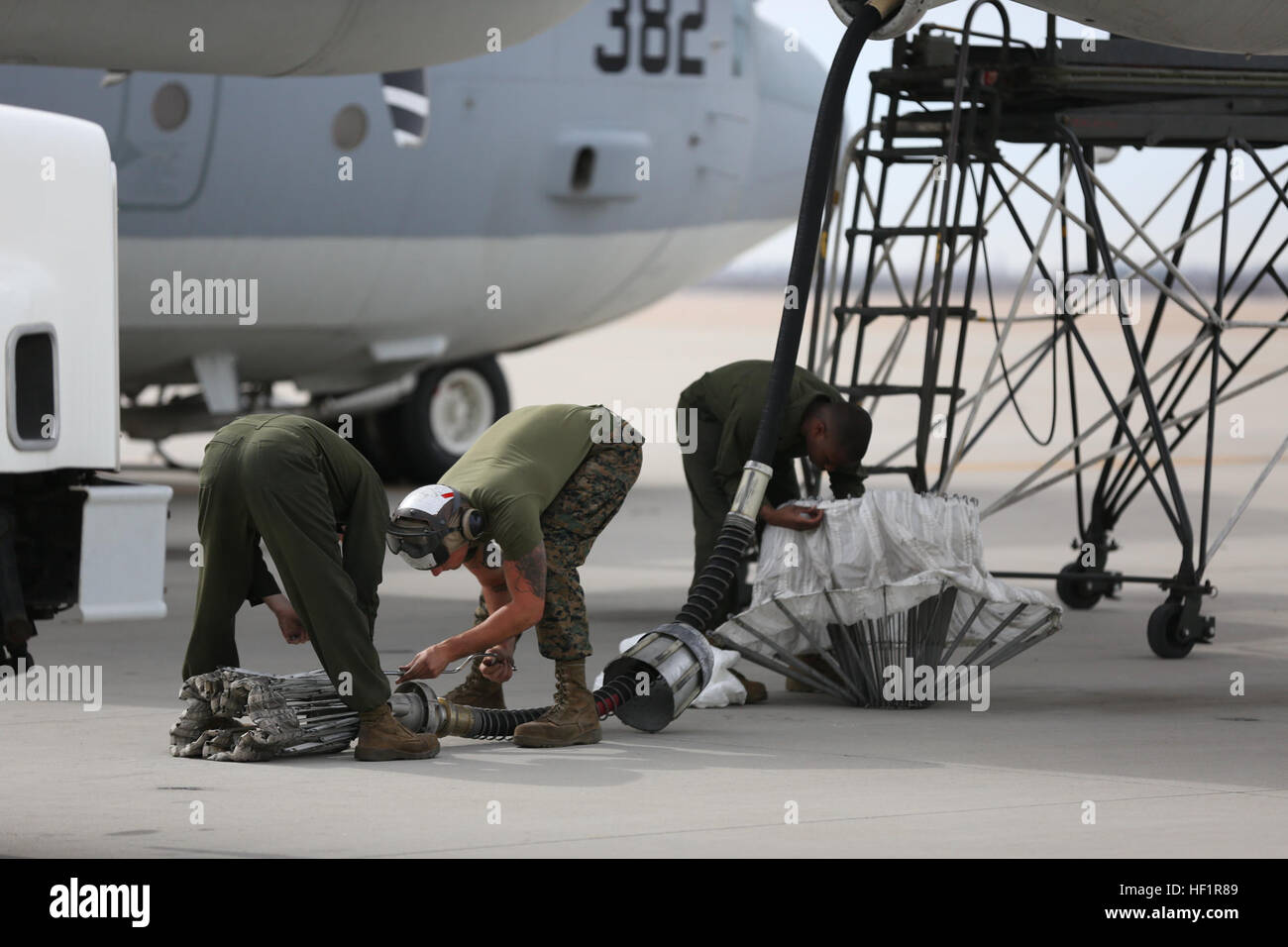 Three Marine airframe mechanics with Marine Aerial Refueling ...