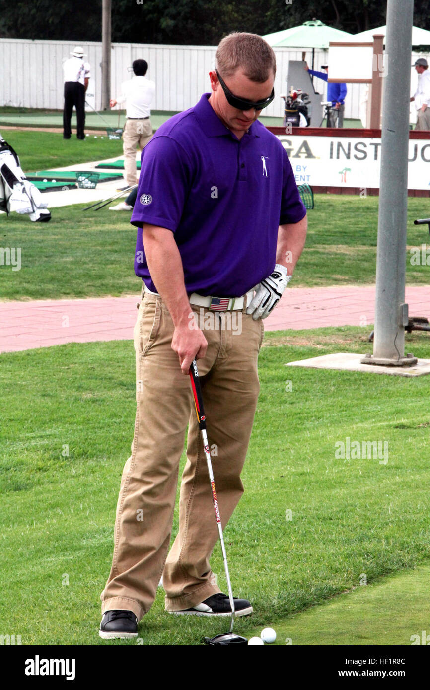 Sgt. Chad Milo examines the quality of the turf at an Operation Game On ...