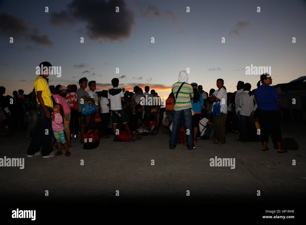 Survivors affected by Typhoon Haiyan wait to board an aircraft in ...