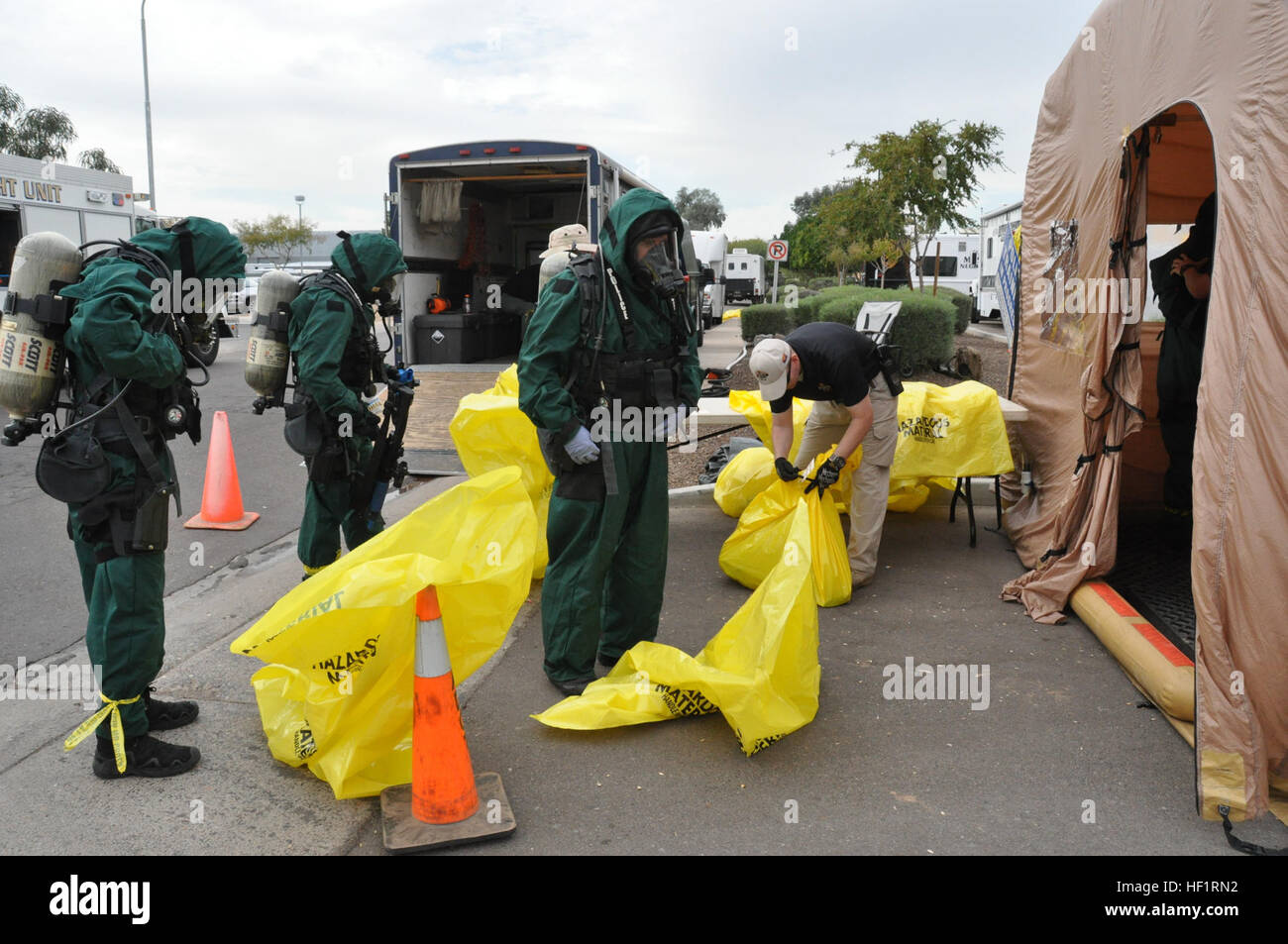 Officers from the Tempe Police SWAT prepare to be checked for hazardous ...