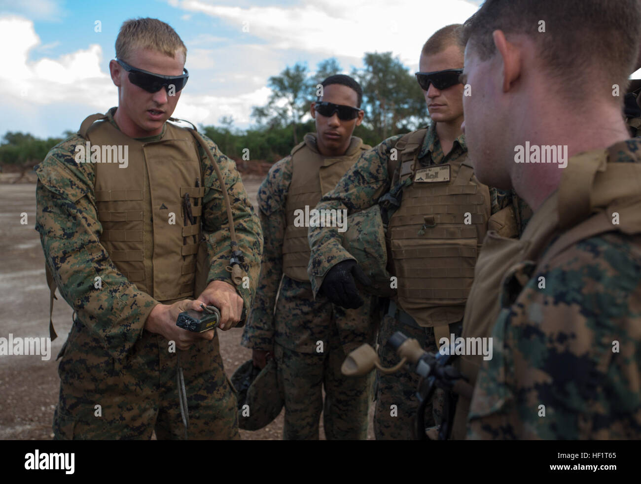 Lance Cpl. Tristan Armstrong, left, demonstrates how to properly charge ...