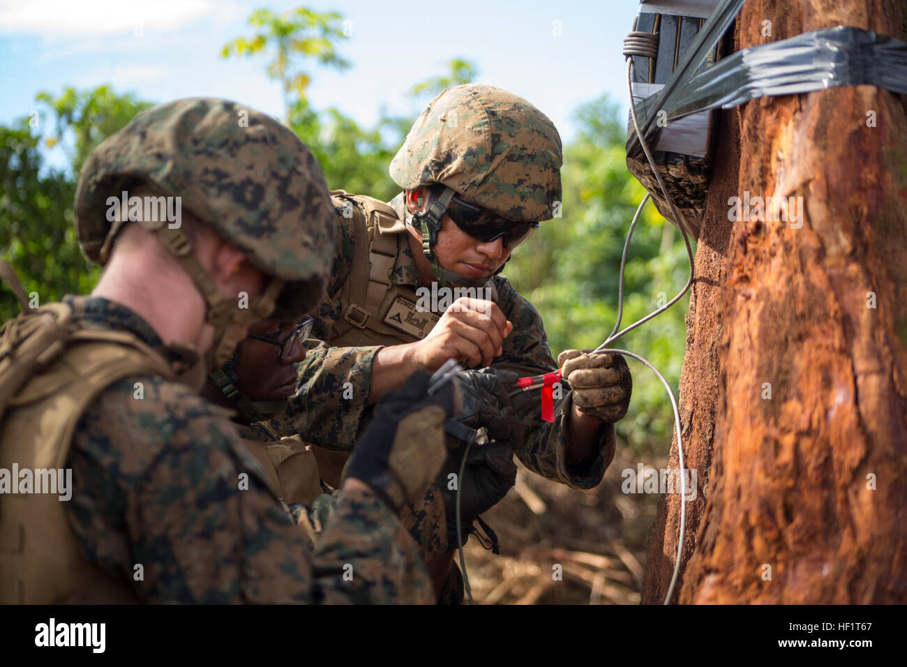 Lance Cpl. Johnny Gomez, center, assembles C4 and TNT charges to ...