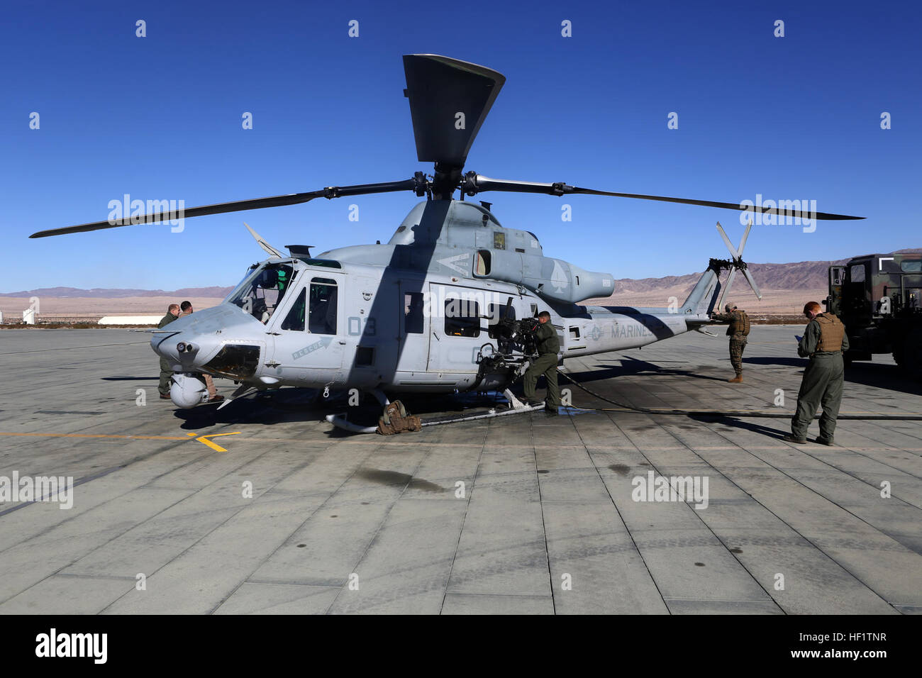 Marines from MWSS 374, MAG-16, 3rd MAW refuel a UH-1Y Venom helicopter ...