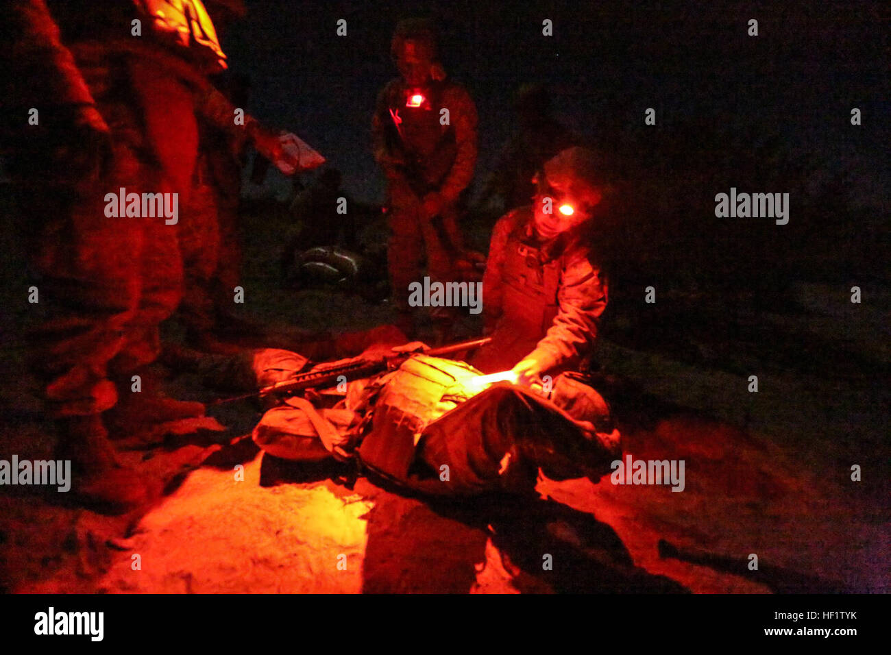 A U.S. Navy Corpsman performs initial battle wound assessments of a ...
