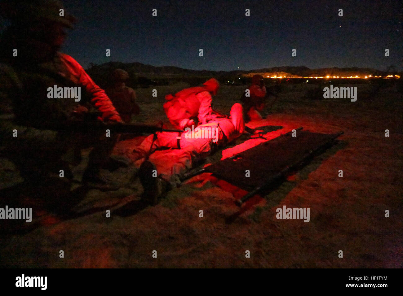 A U.S. Navy Corpsman performs initial battle wound assessments of a ...