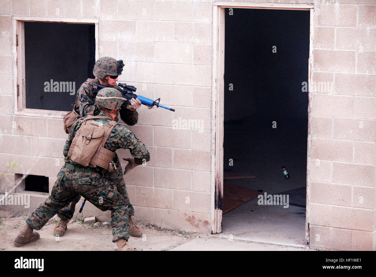 Marines with 2nd Battalion, 1st Marines, throw flash bang grenades at a ...