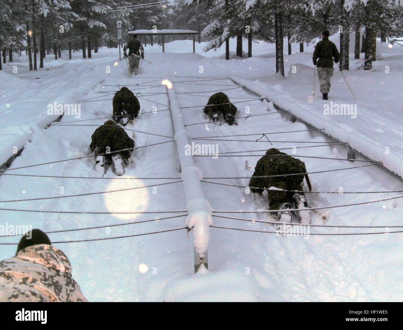 Four Marines with Black Sea Rotational Force 14 low-crawl under one of ...