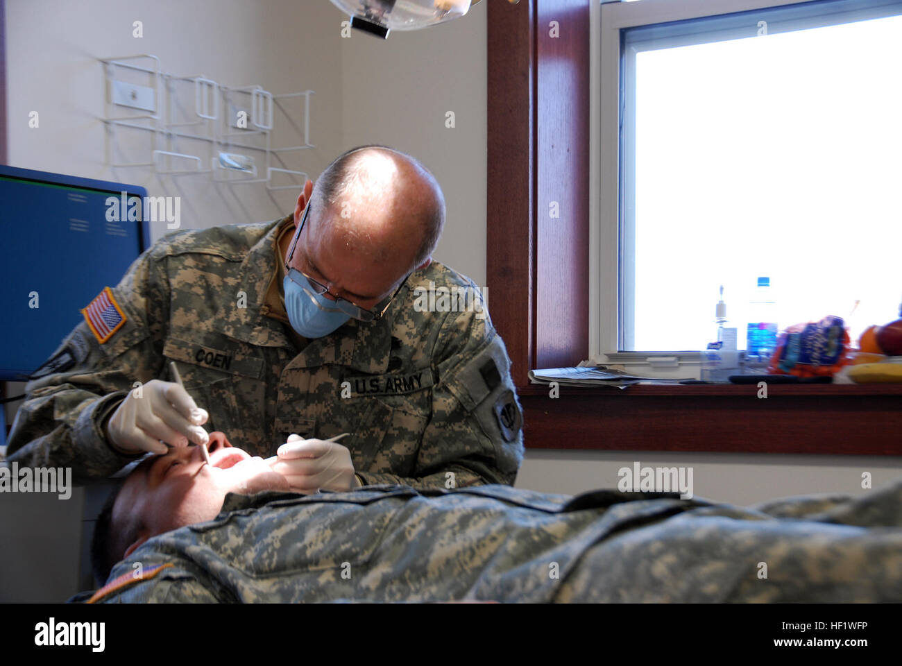 A state dental officer conducts a dental examination during soldier ...