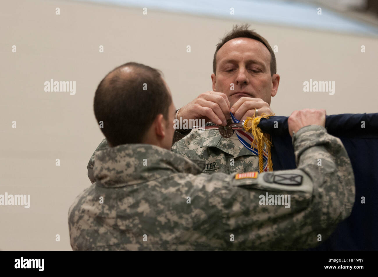 U.S. Army Brig. Gen. Brian Carpenter attaches the Valorous Unit Award ...