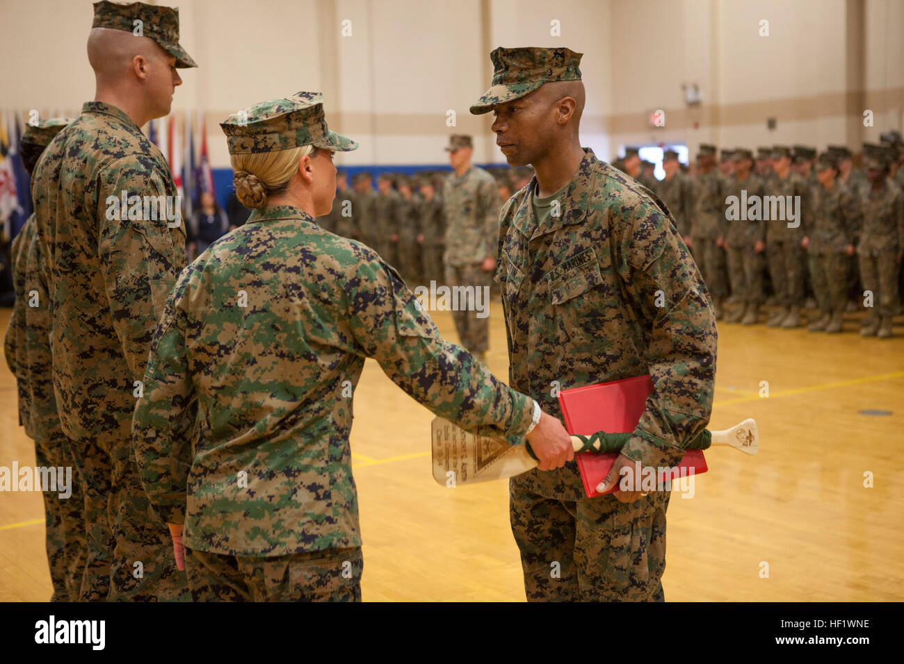 A Marine Corps company commander presents a Certificate of Commendation ...